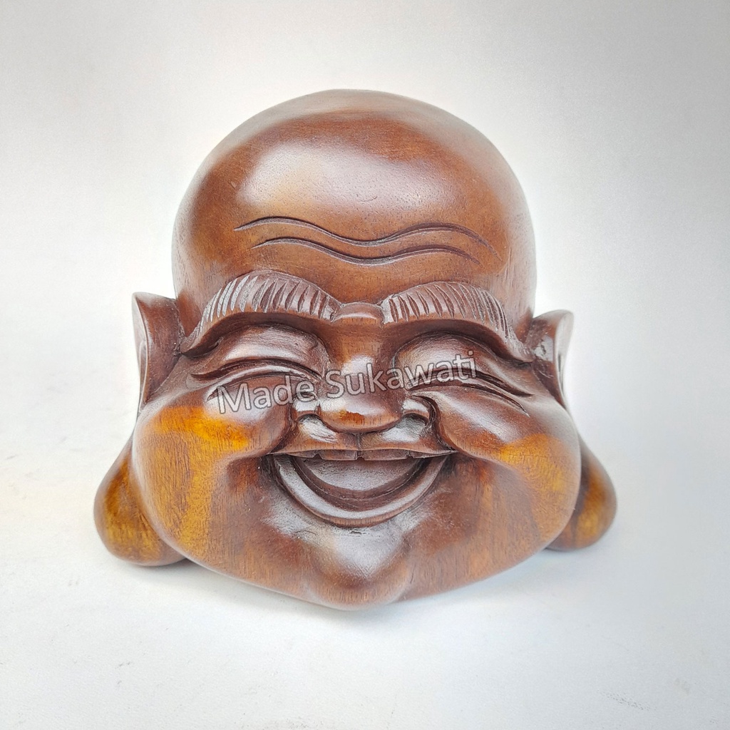 Wooden statue of the head of the grandfather, Pekong, laughing ...