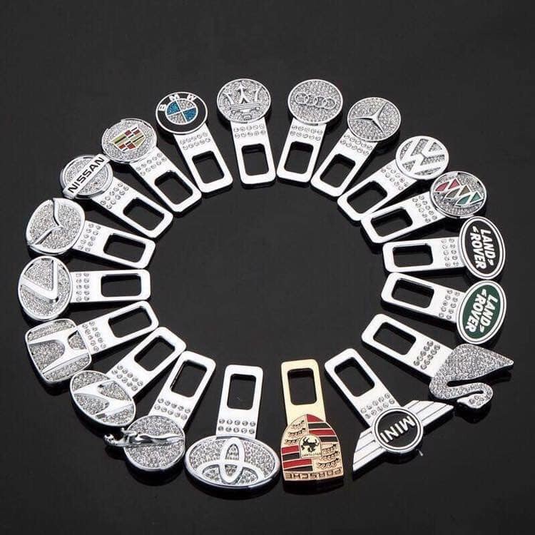 2 stone-encrusted seat belt latches with high-end car brand logo ...