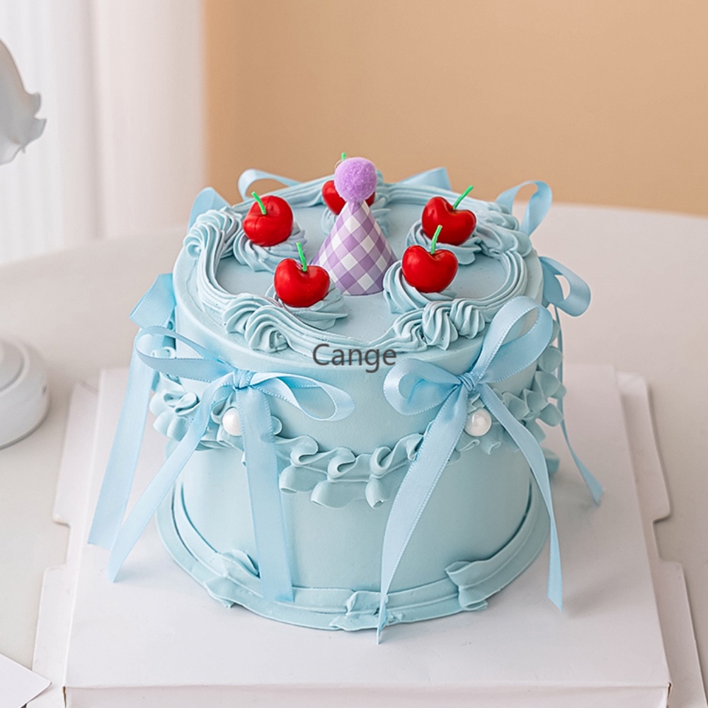 Ballet style cake decoration with macaron colored ribbon and bow ...