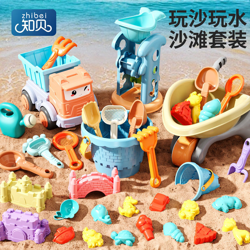 Children's beach toy car, baby swatting in the water and digging sand ...