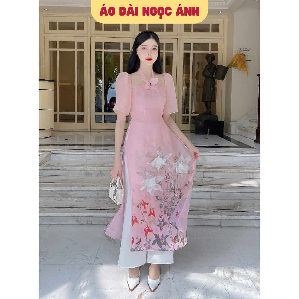 Innovative female Ao Dai Ngoc Anh pink with bow overalls in front of ...