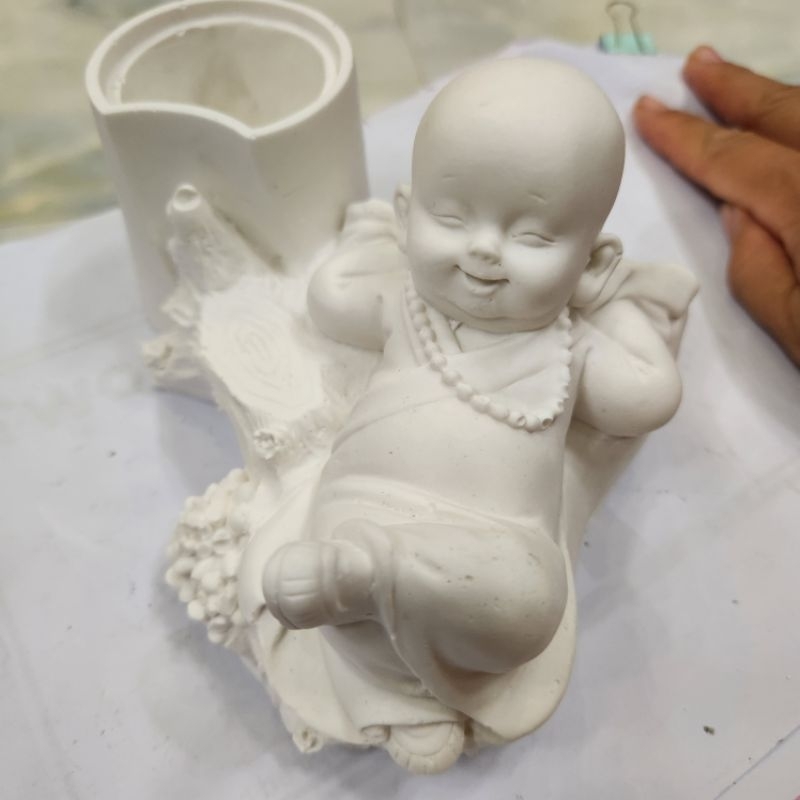 The Coloring Plaster Statue Of The Little Uncle Is At The Base Of The ...