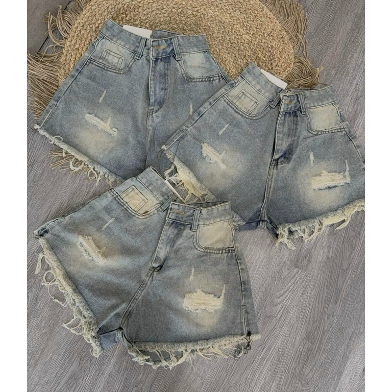 Ripped jeans shorts with tassels at the hem and thigh slits on both ...