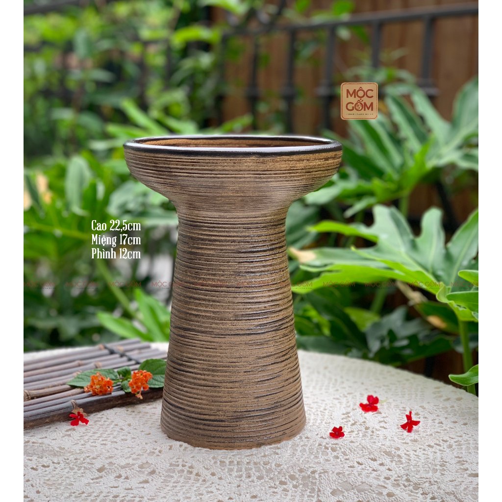 Flower vase shaped like a lake with tall legs and brown veins of Bat ...