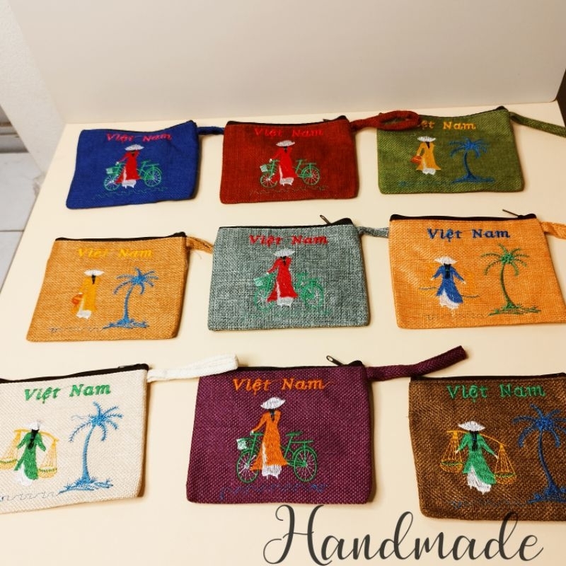 Mini wallet made of jute fabric embroidered with the image of a ...