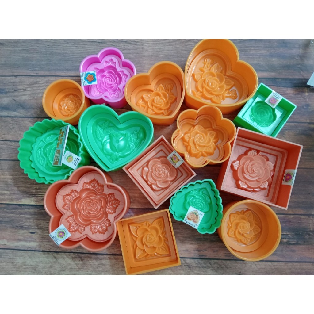 Collection of many models and sizes of rose-shaped sticky rice molds ...