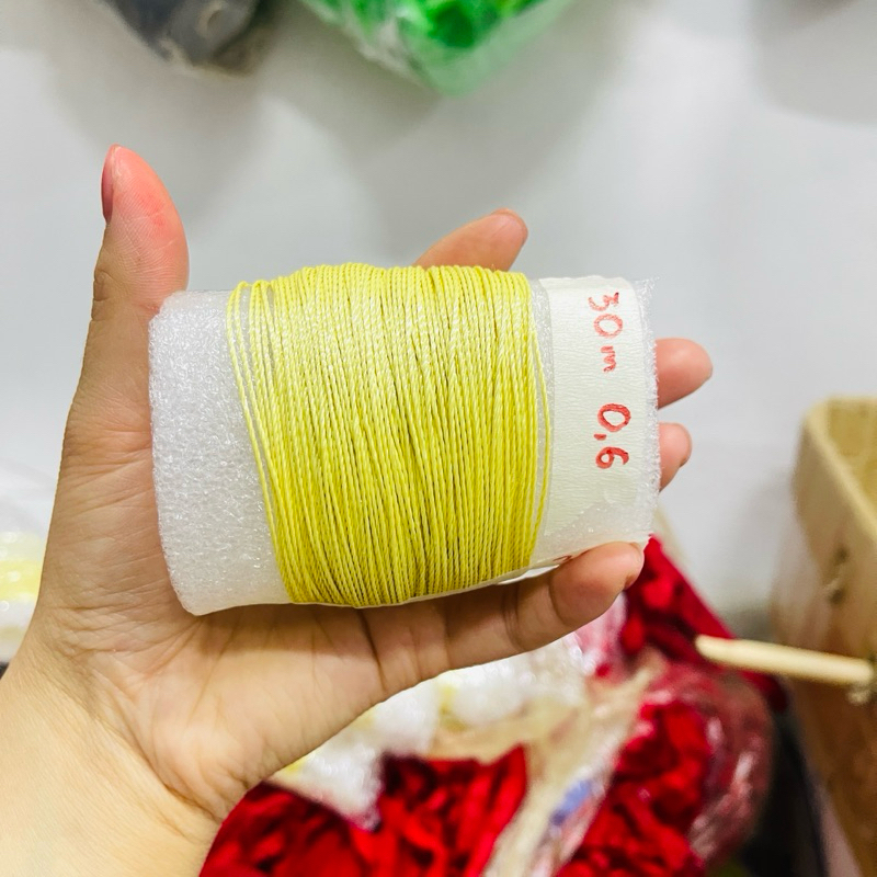 Asbestos string used to make poles and wrap assembled kite spokes ...