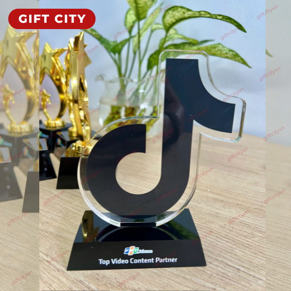 Crystal honor trophy in the shape of musical notes, printed with labels ...