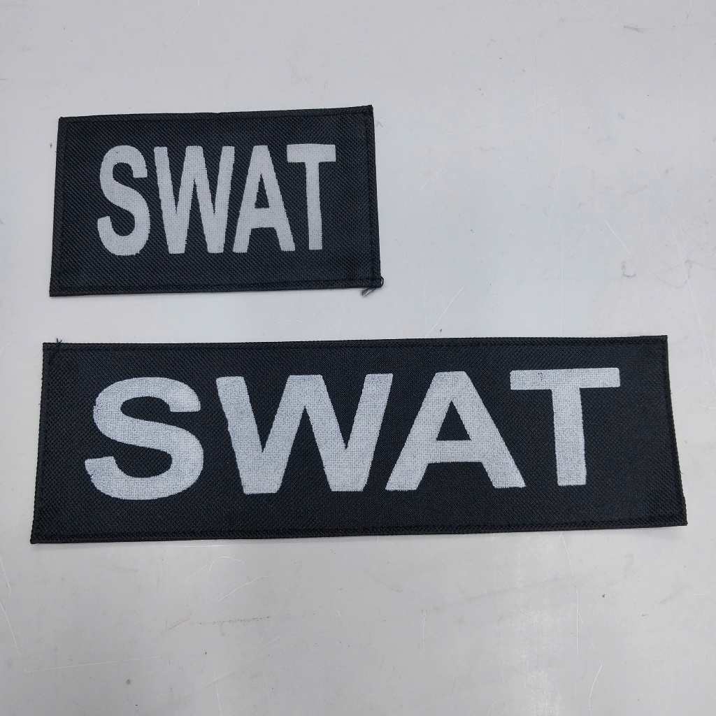 Swat sticker attached to security, bodyguard and security staff armor ...