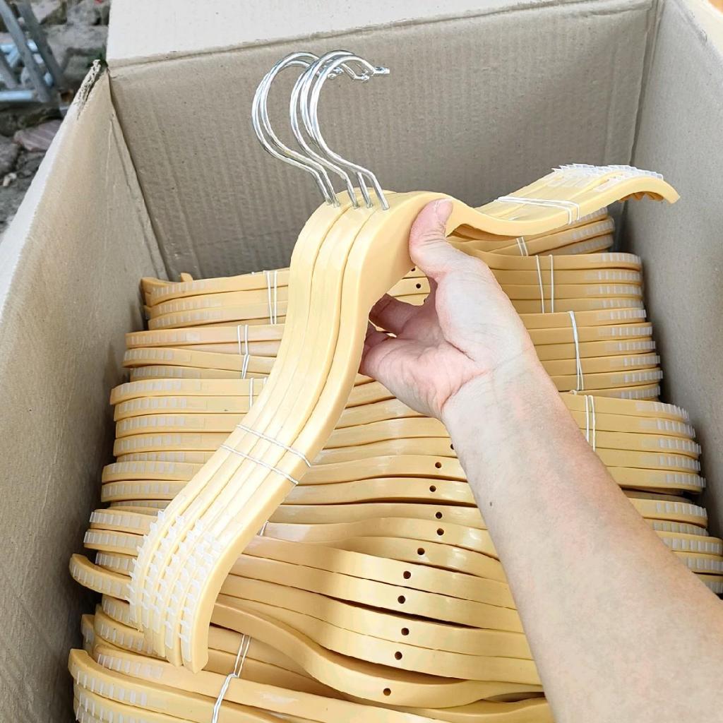 Bamboo-shaped plastic hanger with yellow anti-slip padded shoulders ...