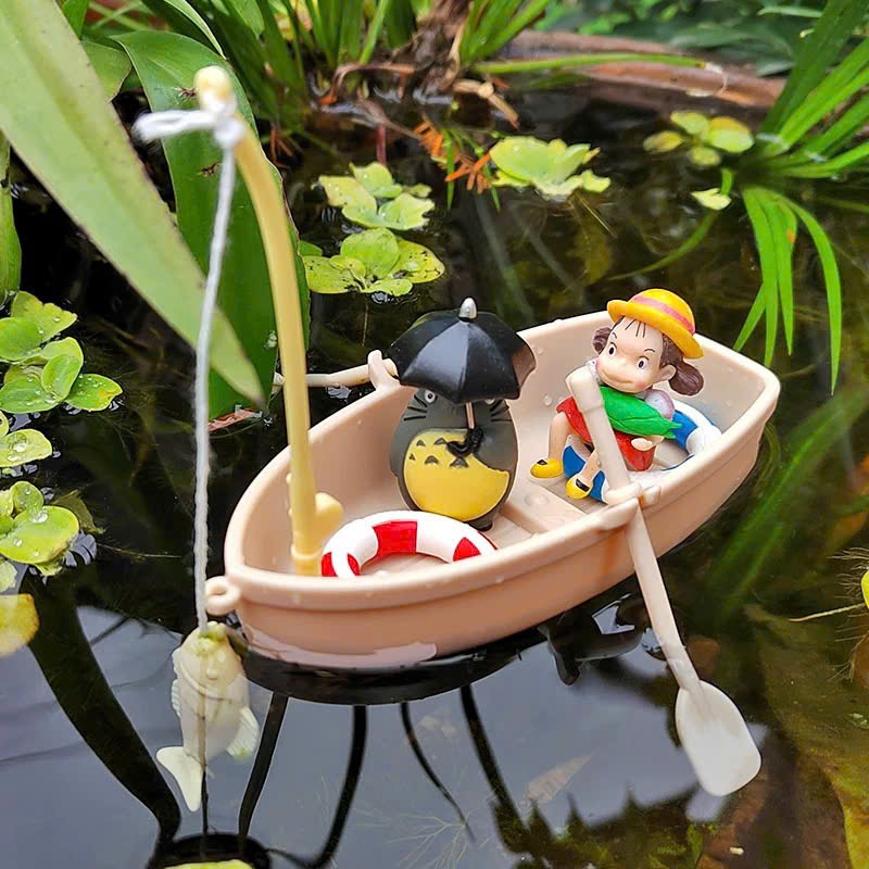 Floating boat model decorates aquarium. Fishing cat model on a boat ...