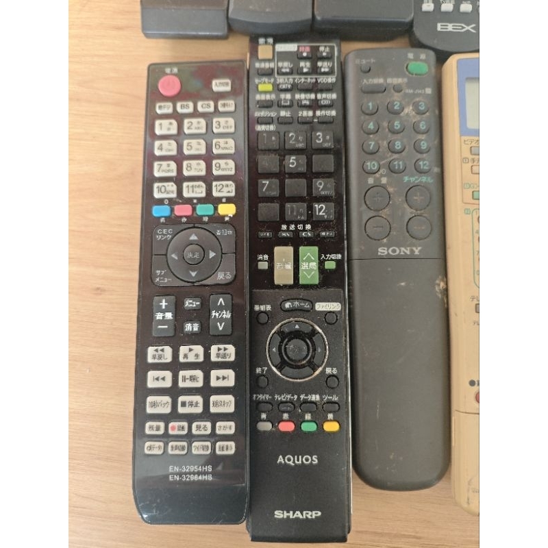 15 domestic remotes: TV. vhs player. sound system: sony. sharp. victor ...