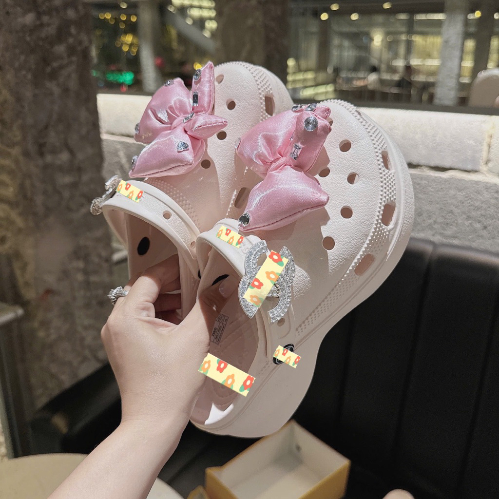 CAST PLASTIC SLIPPERS WITH BEAUTIFUL PINK BOW TICKER (5 INCH HIGH SOLE ...
